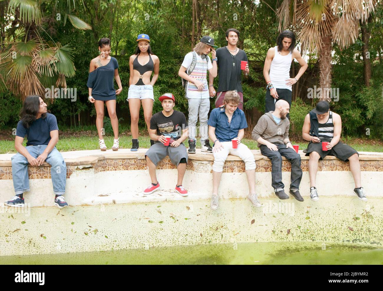 Teenage friends hanging out swimming pool hi-res stock photography and ...