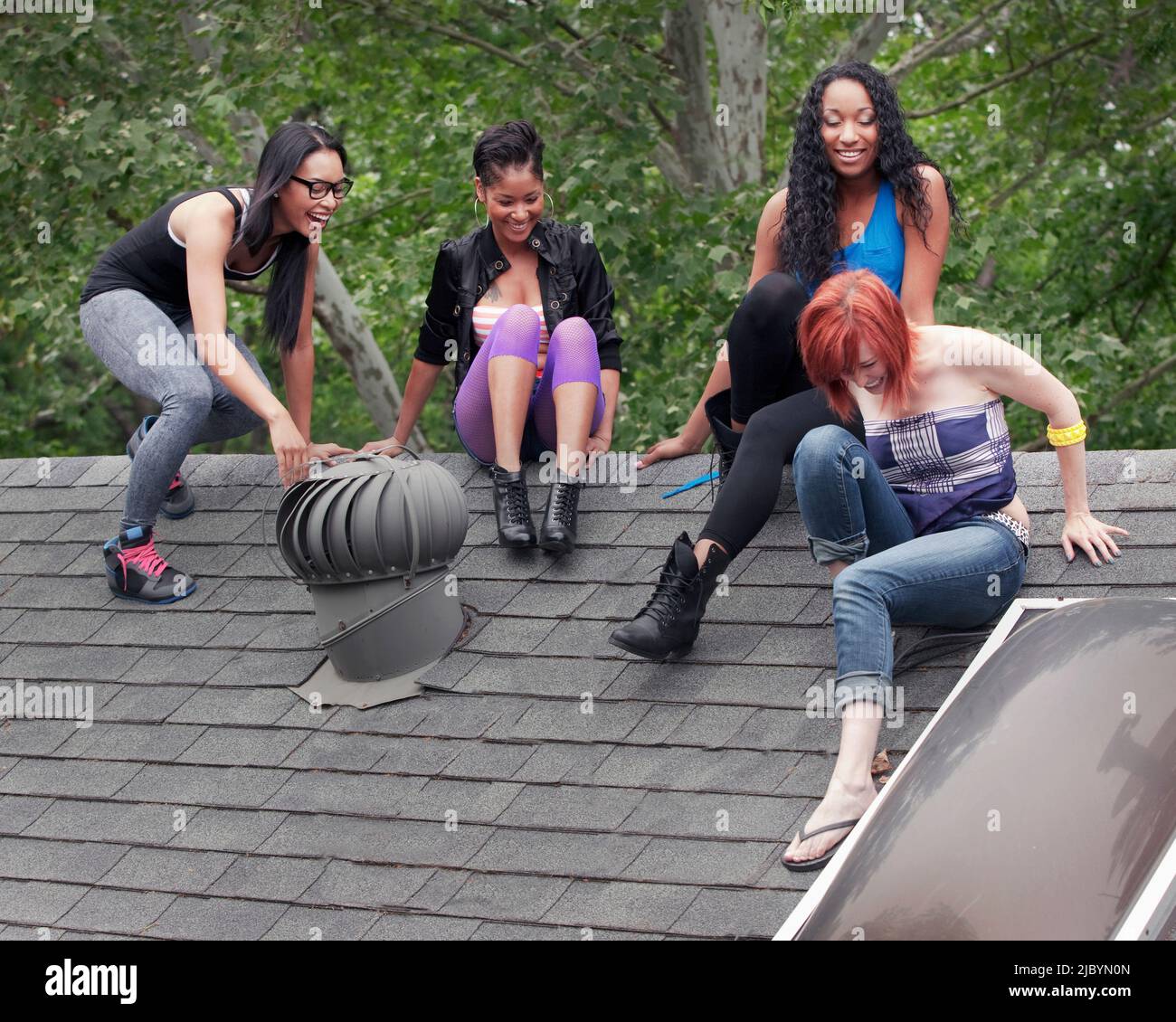 Women hanging out together on rooftop Stock Photo - Alamy