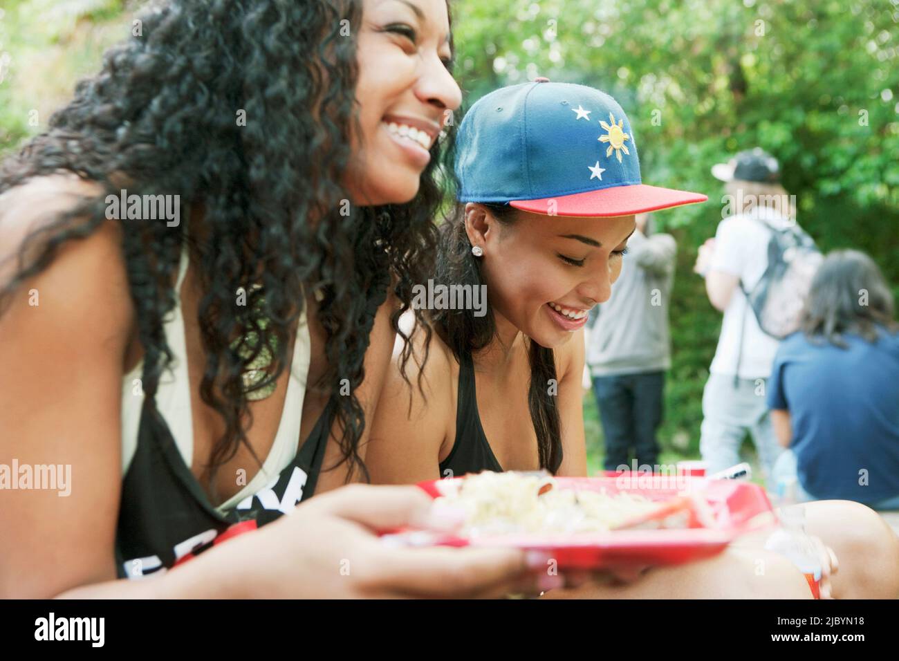 Friends hanging out and eating together Stock Photo - Alamy
