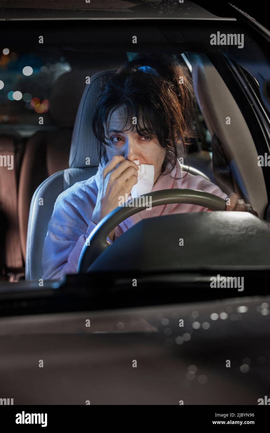Sick woman driving car at night Stock Photo - Alamy