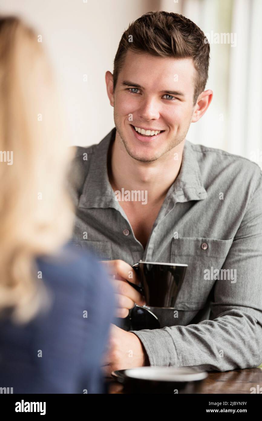 Caucasian couple drinking coffee together Stock Photo - Alamy