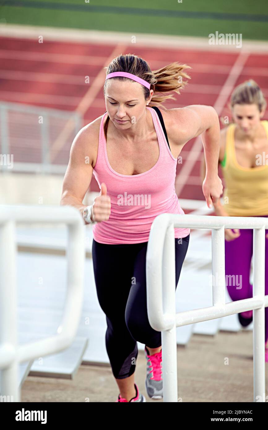 Athletes running up bleachers Stock Photo - Alamy