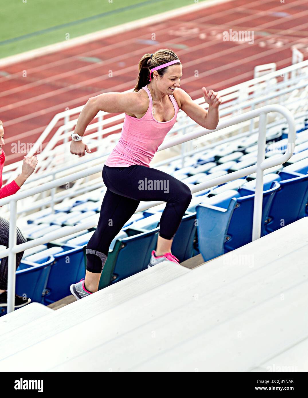Caucasian athlete running up bleachers Stock Photo - Alamy