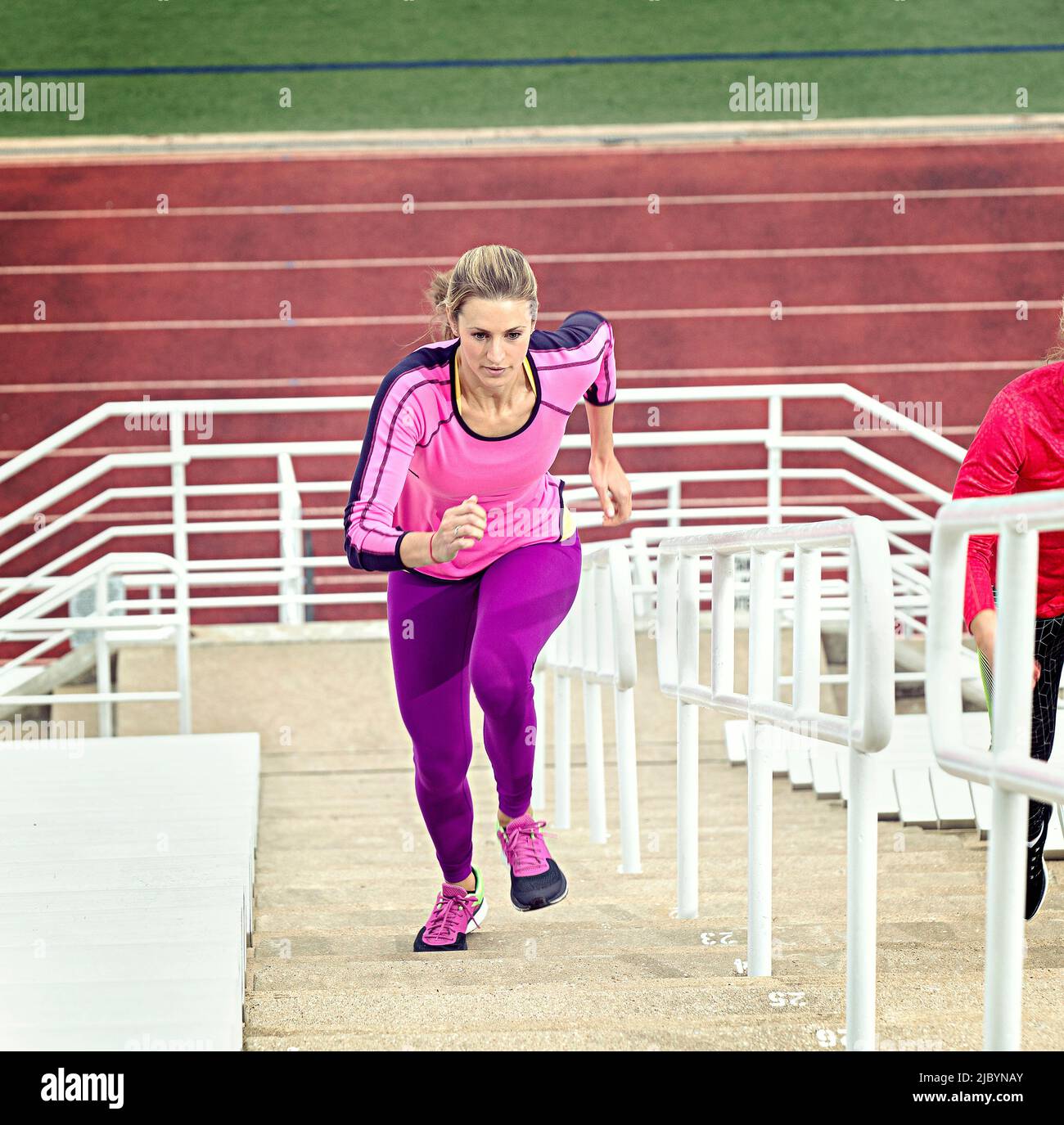 Athlete running up bleachers Stock Photo - Alamy