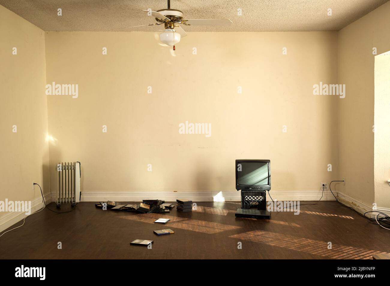 Television on crate in barren apartment Stock Photo - Alamy