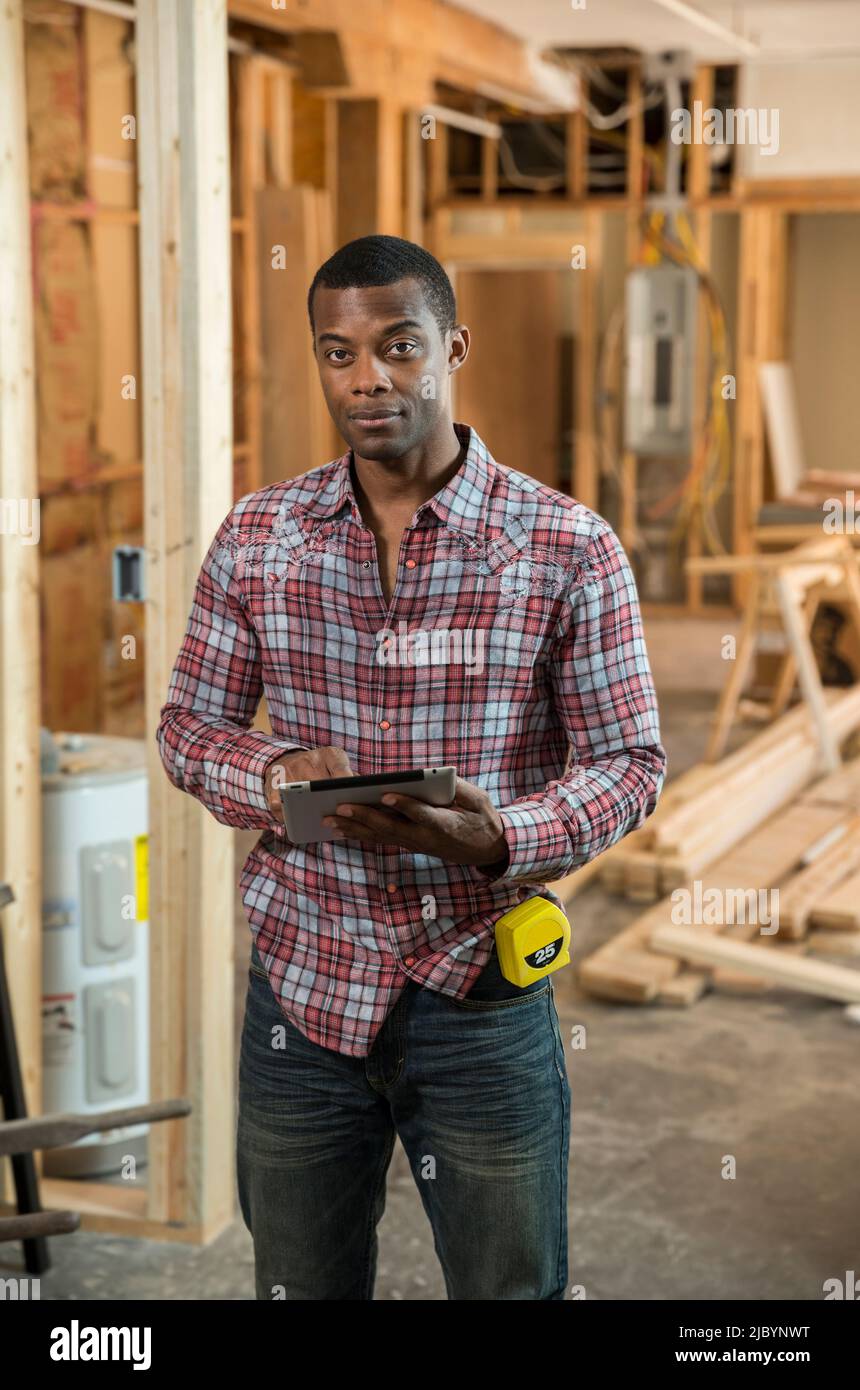 Worker using tablet computer at construction site Stock Photo - Alamy