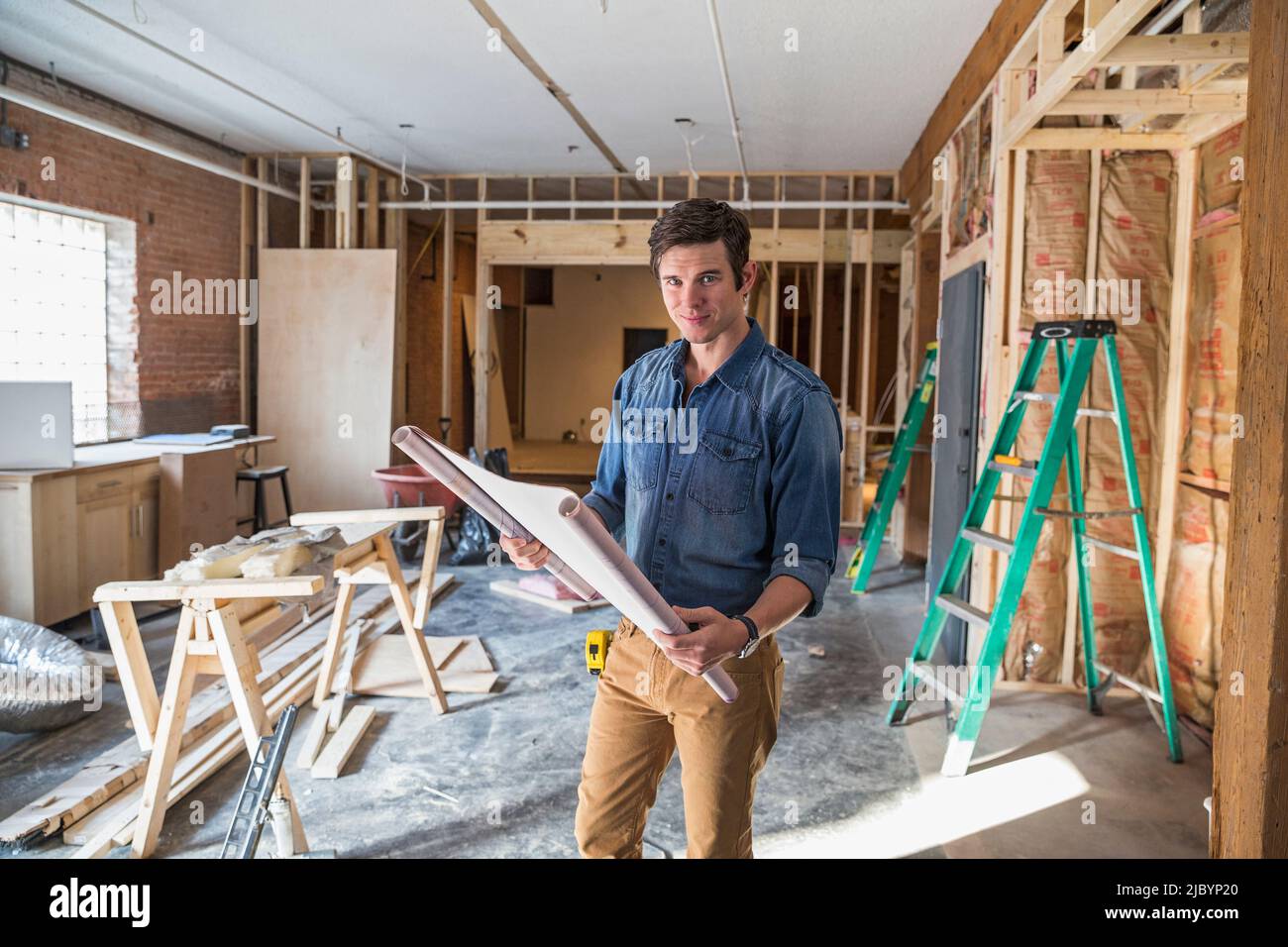 Architect reading blueprints at construction site Stock Photo - Alamy