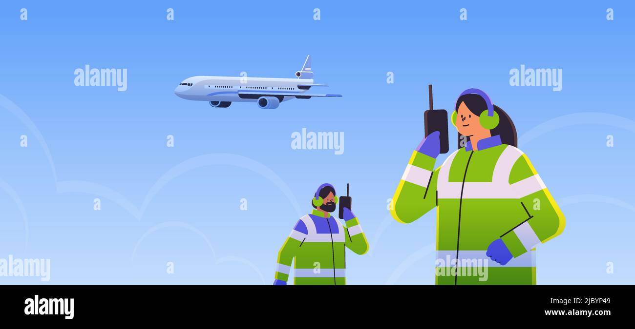 airport workers marshallers communicating over walkie-talkie with air ...