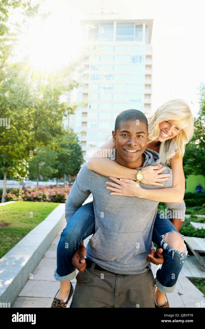 Man giving girlfriend piggyback ride Stock Photo - Alamy