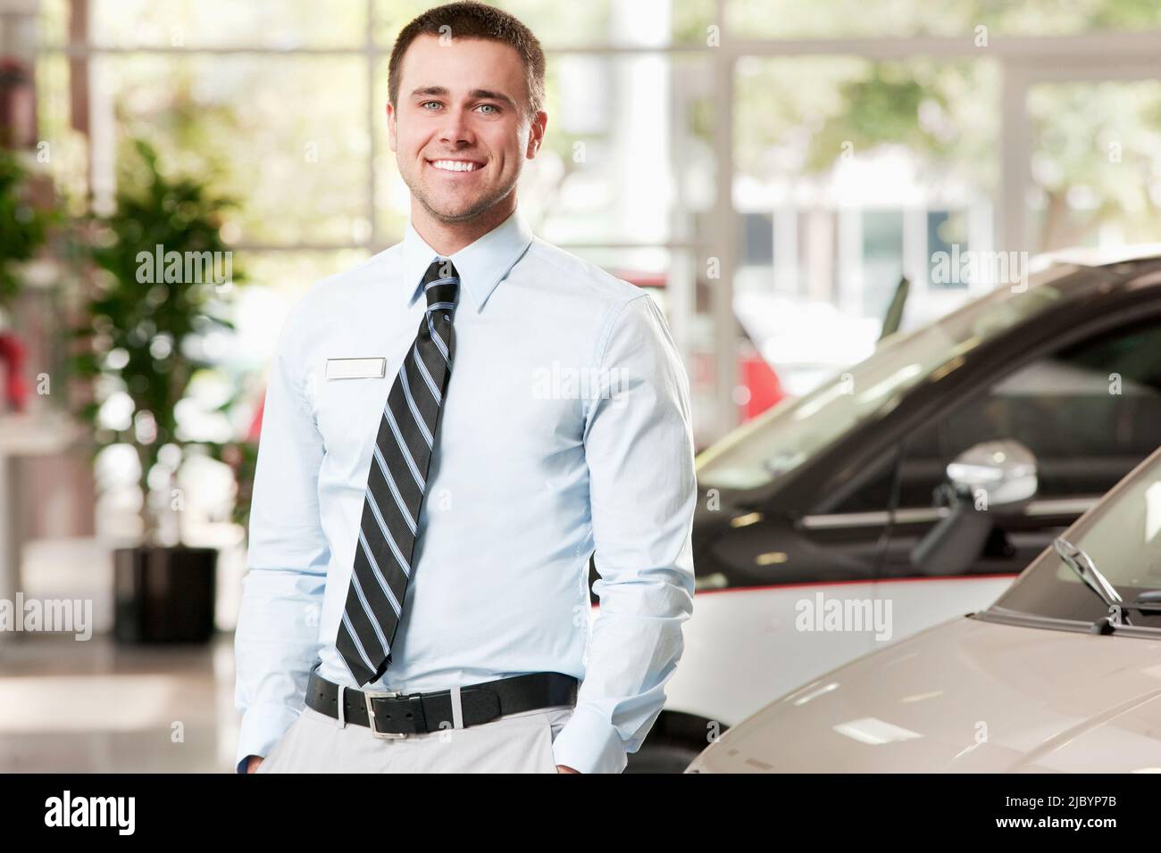 Salesman posing car showroom hi-res stock photography and images - Alamy