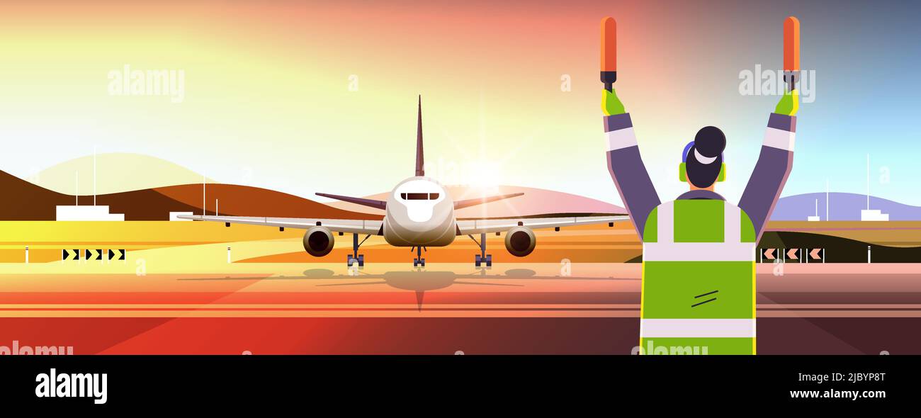 aviation marshaller supervisor in uniform navigate with light sticks ...