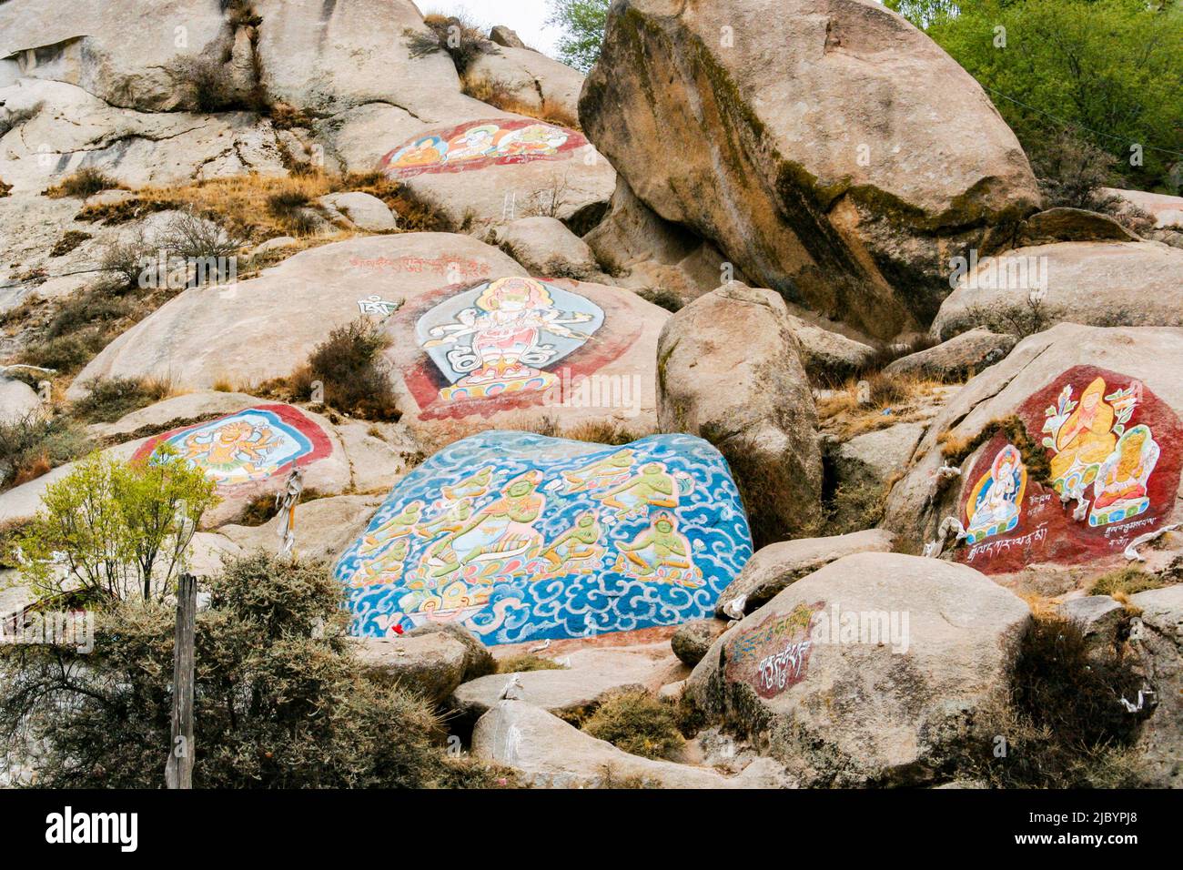 Tibetan Buddhist paintings on mani stones (om mani padme hum) in the ...