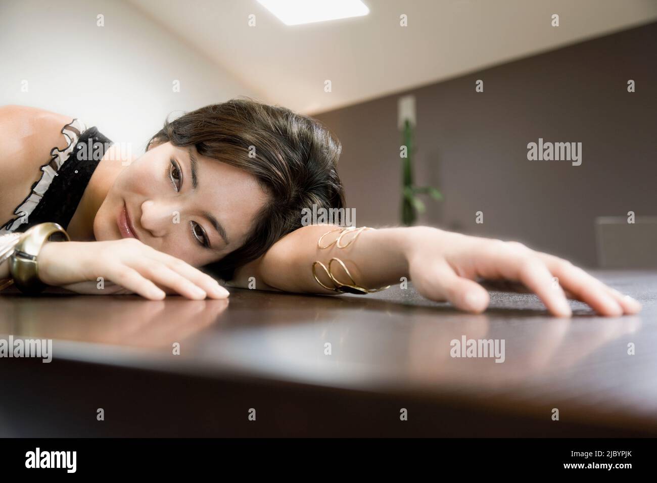Korean woman leaning on table Stock Photo - Alamy
