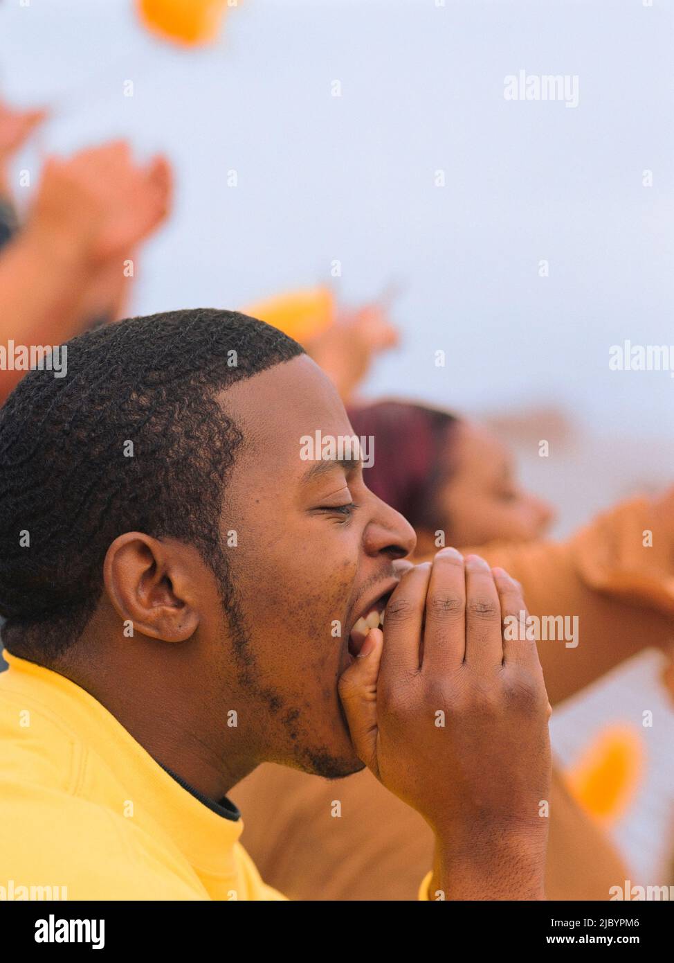 African man cheering at sporting event Stock Photo - Alamy