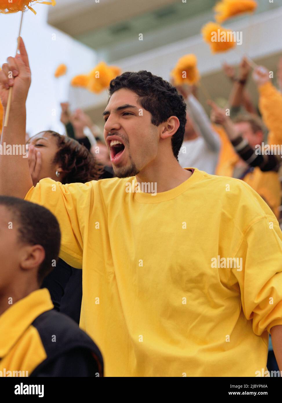 Hispanic man cheering at sporting event Stock Photo - Alamy