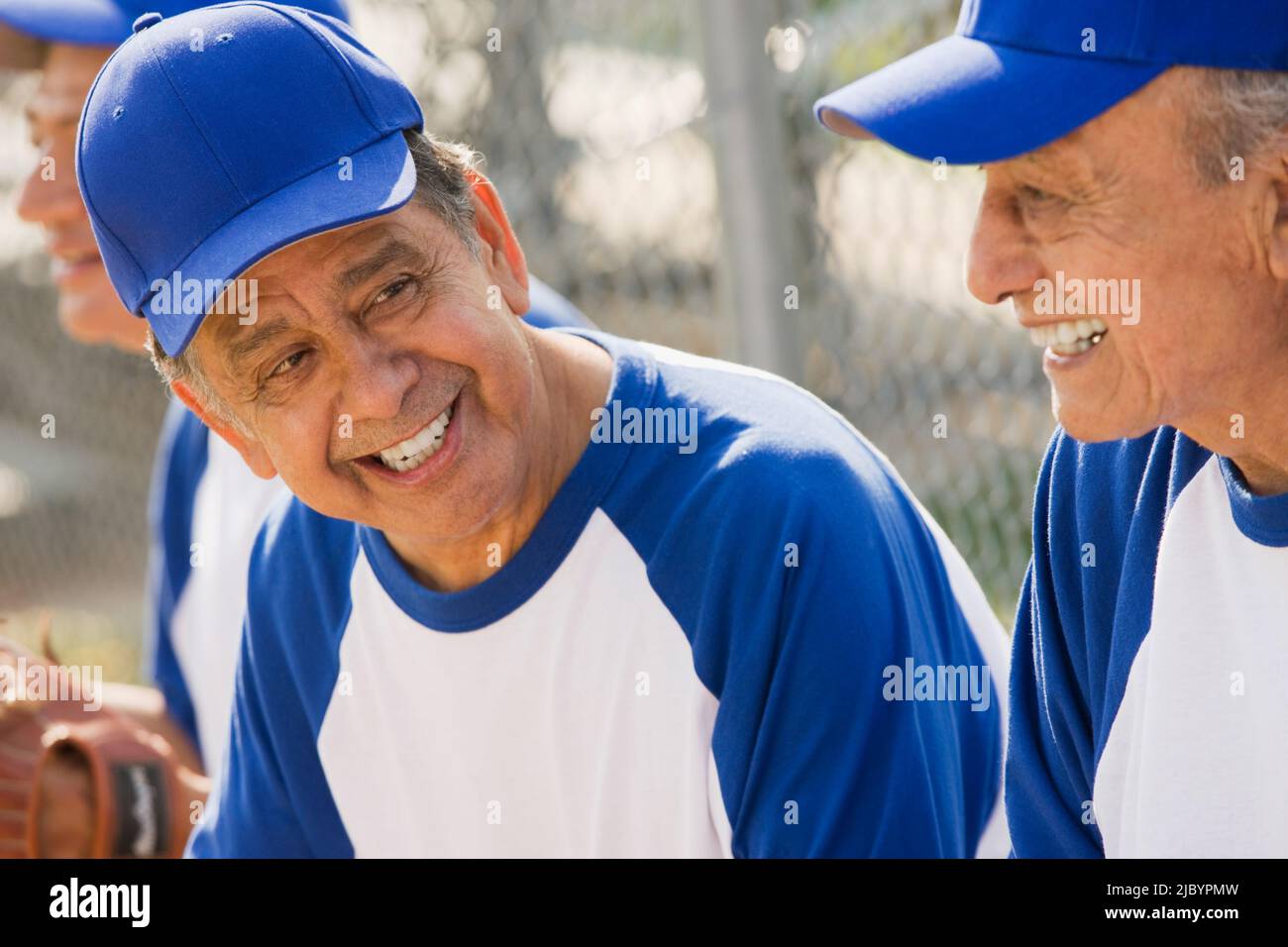 Senior Hispanic men playing on baseball team Stock Photo - Alamy