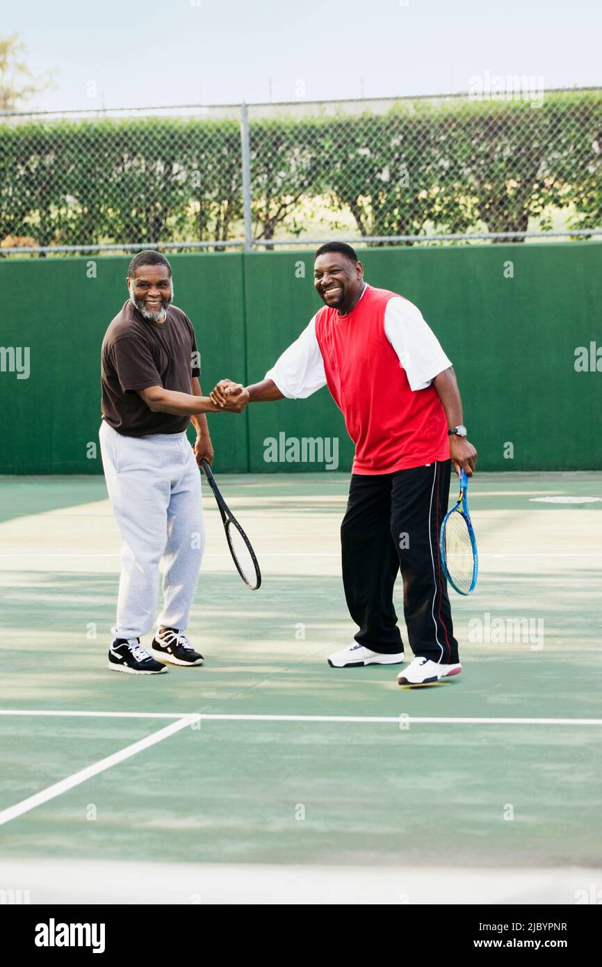 African men playing doubles tennis Stock Photo - Alamy