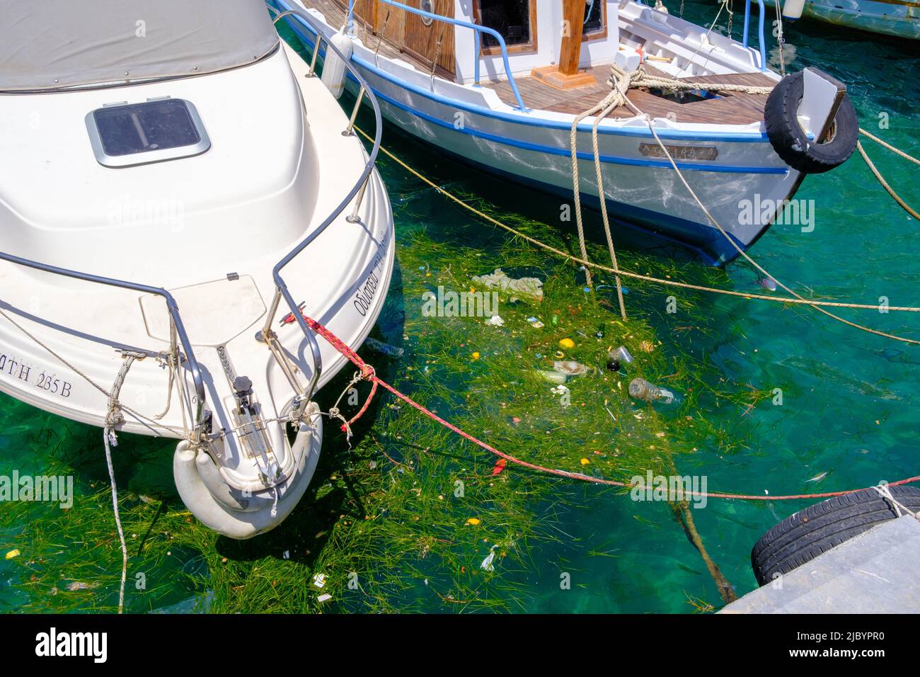 on the sea in the harbor floats a pile of plastic waste in Crete Stock ...