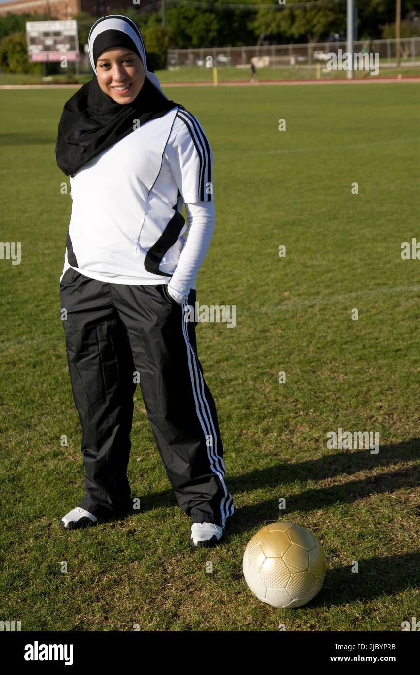 Muslim teenager standing with soccer ball Stock Photo - Alamy