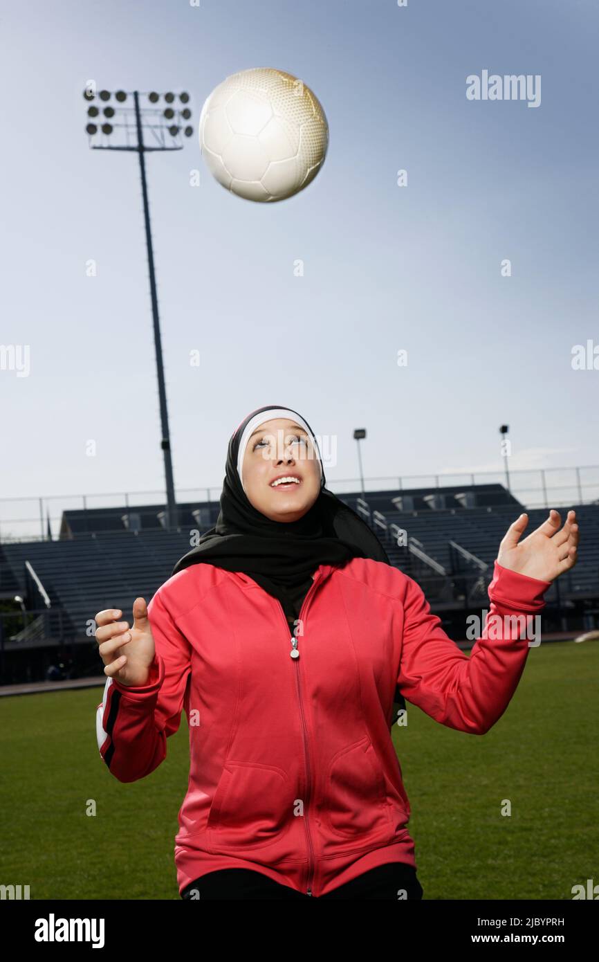 Muslim teenager practicing with soccer ball Stock Photo - Alamy