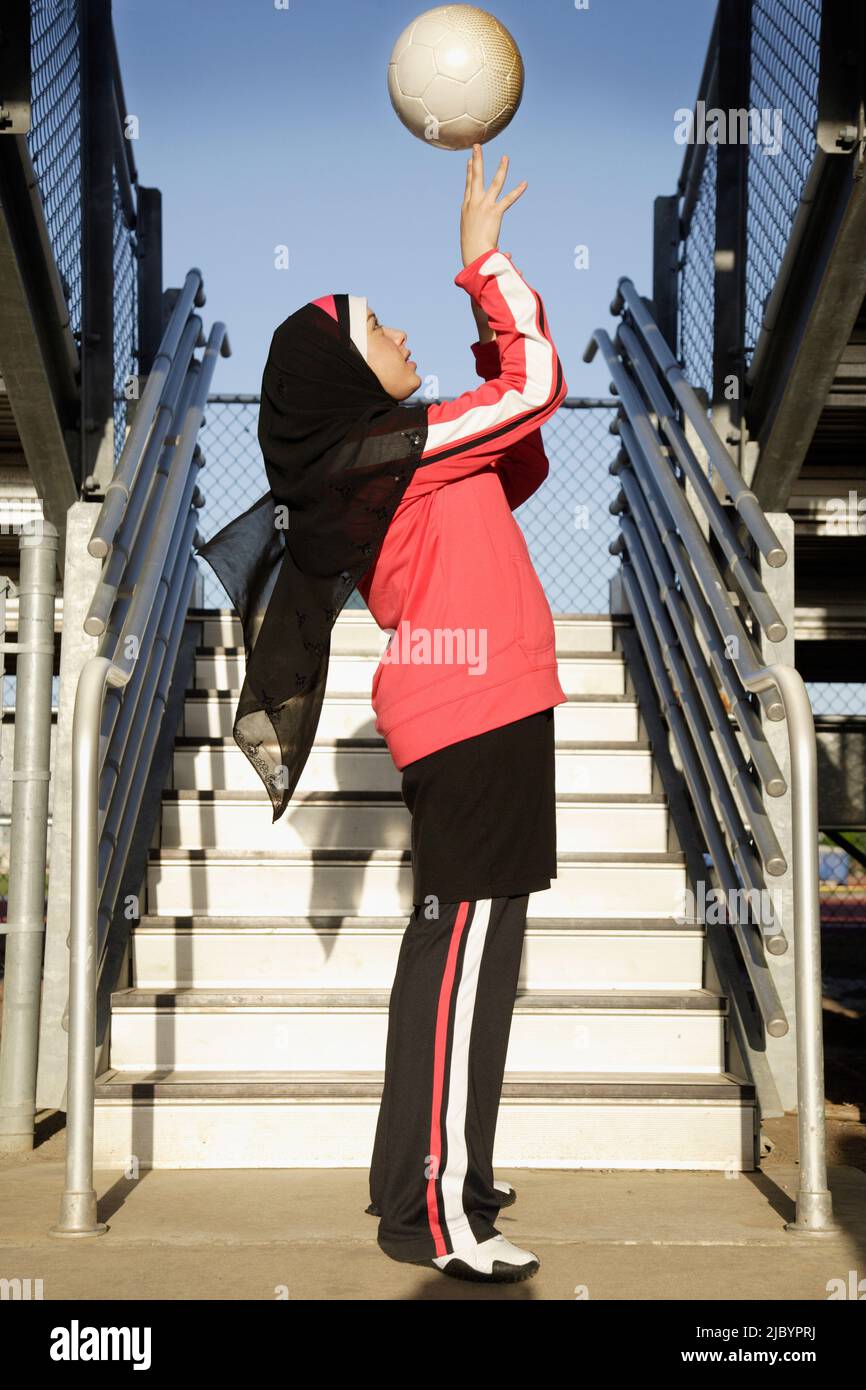 Muslim teenager practicing with soccer ball Stock Photo - Alamy