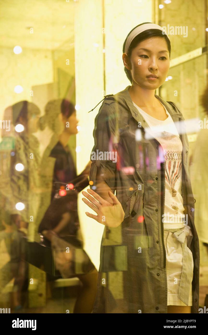 View through glass young woman hi-res stock photography and images - Alamy