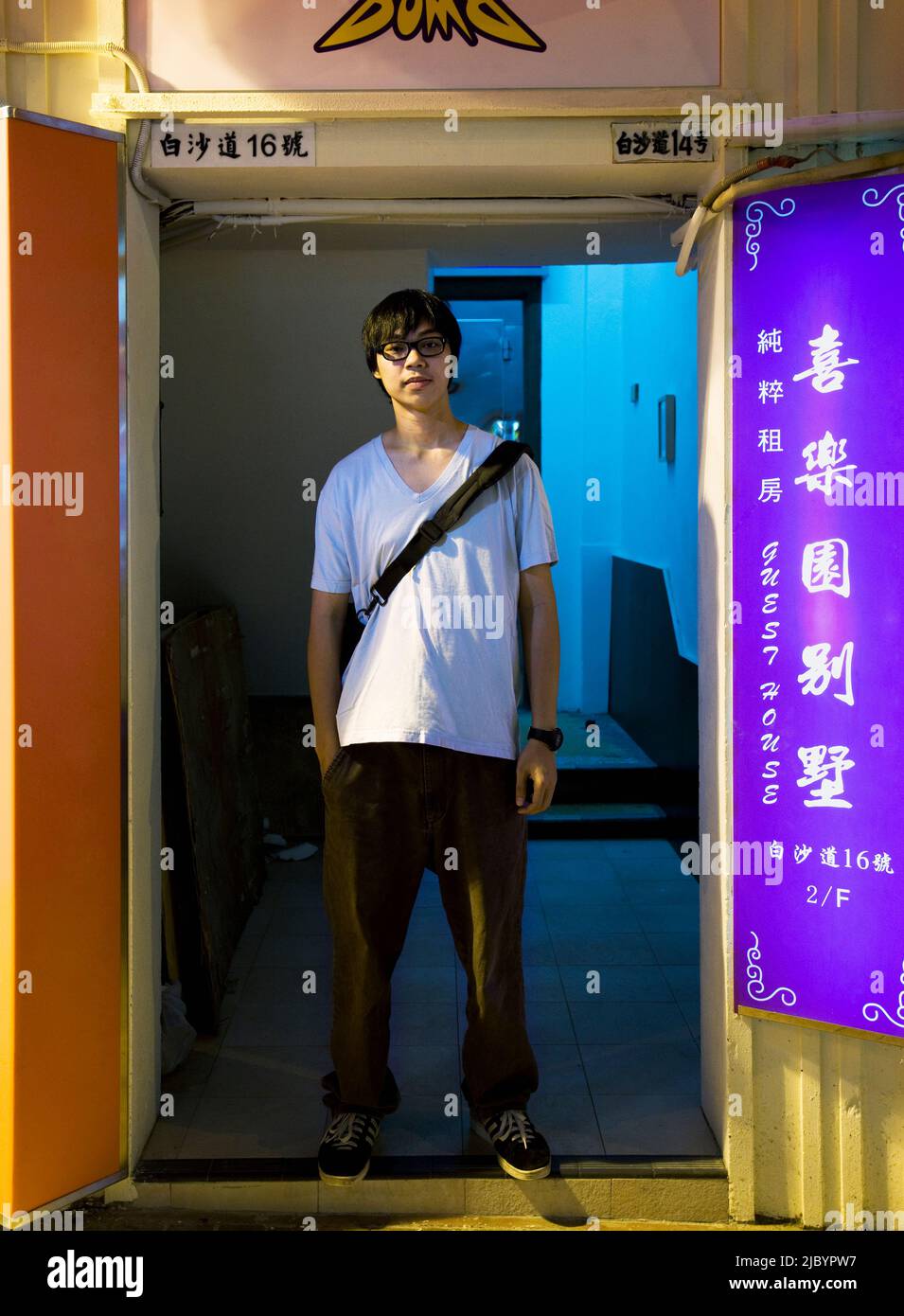 Asian man standing in doorway Stock Photo - Alamy