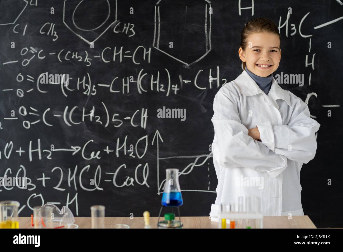 Smiling little student scientist making experiments in laboratory ...