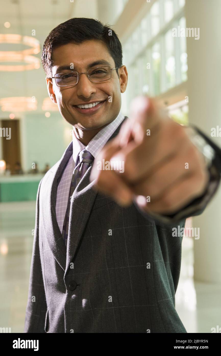 Indian businessman pointing Stock Photo - Alamy