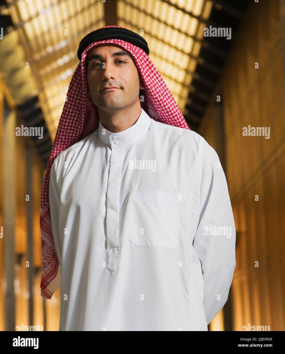 Middle Eastern man in traditional clothing in hallway Stock Photo - Alamy