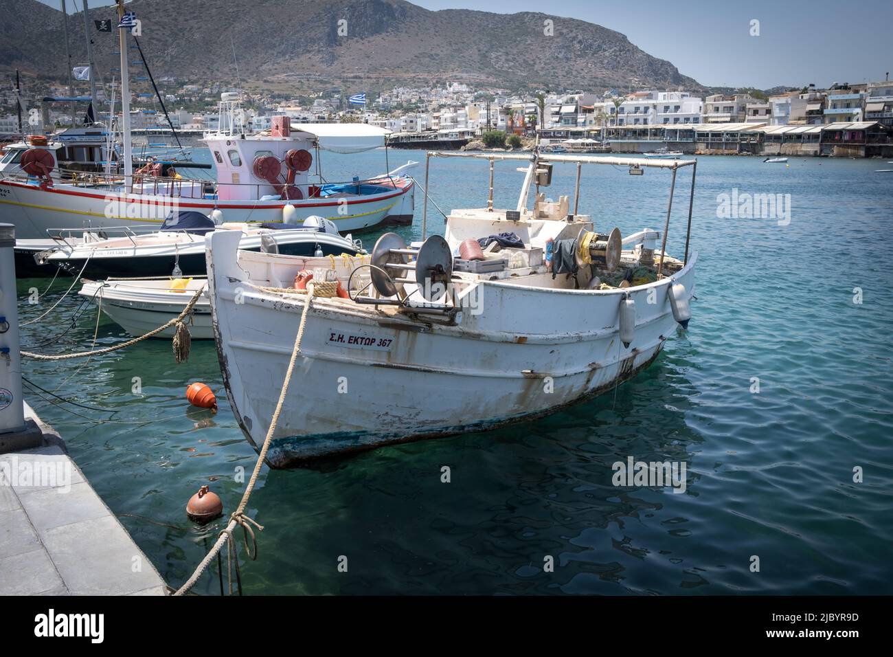 a greek fishing boat floats in the harbor of Chersonisos Stock Photo ...