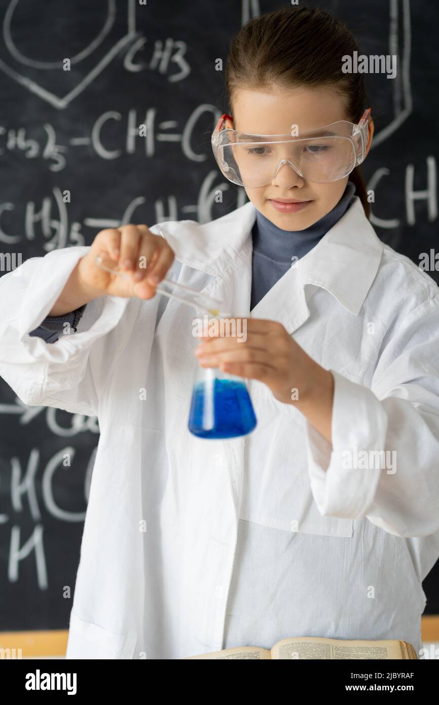 Lovely little girl scientist excite to examine the color chemical in ...