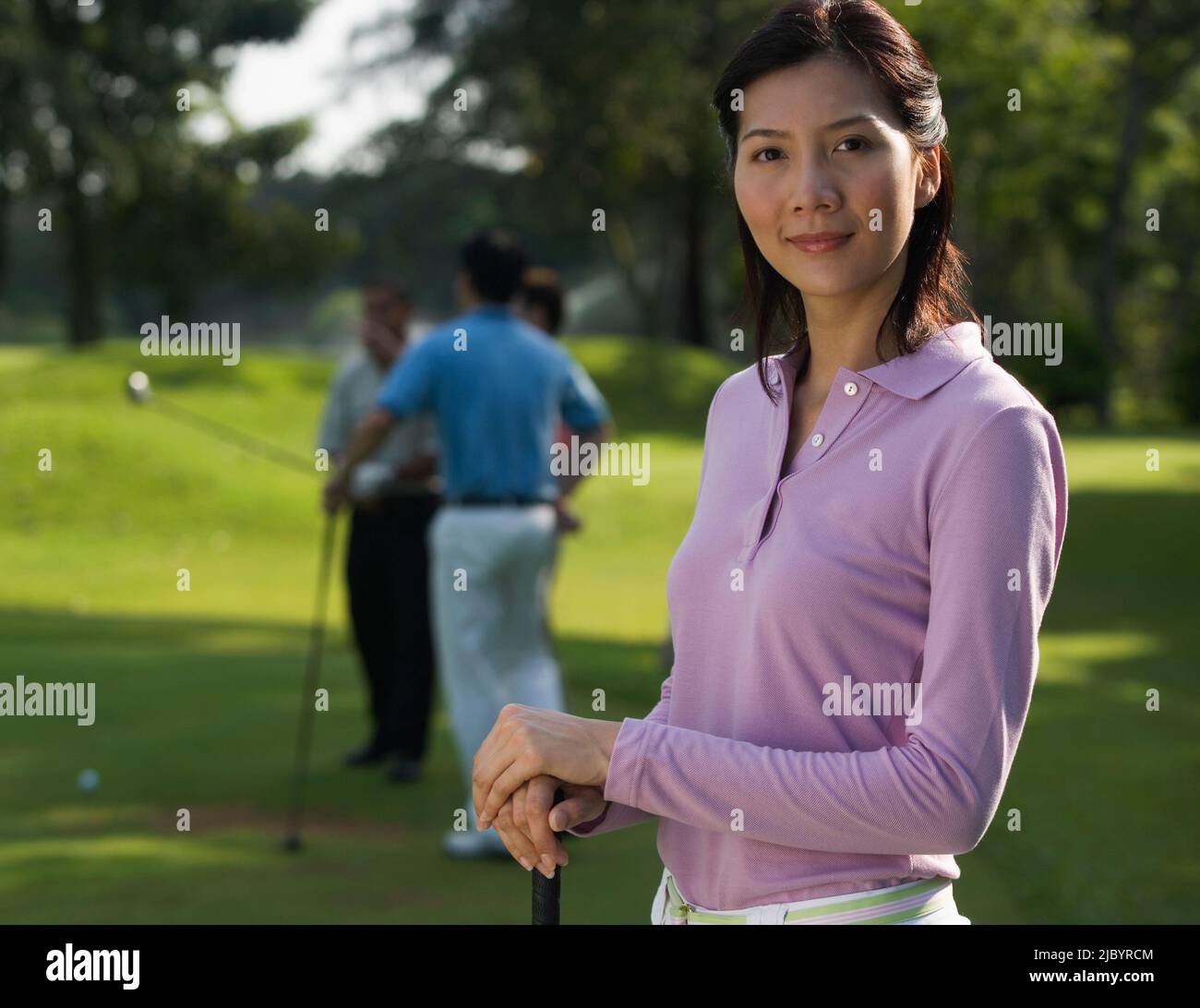Chinese woman playing golf Stock Photo - Alamy