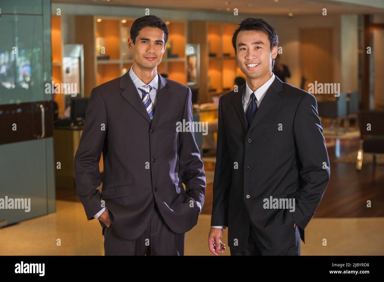 Chinese businessmen standing in bar Stock Photo - Alamy