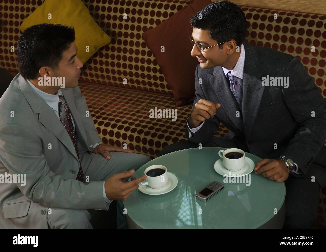 Businessmen drinking coffee together in cafe Stock Photo - Alamy