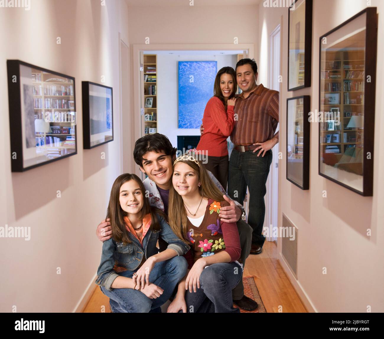 Family standing in corridor together Stock Photo - Alamy