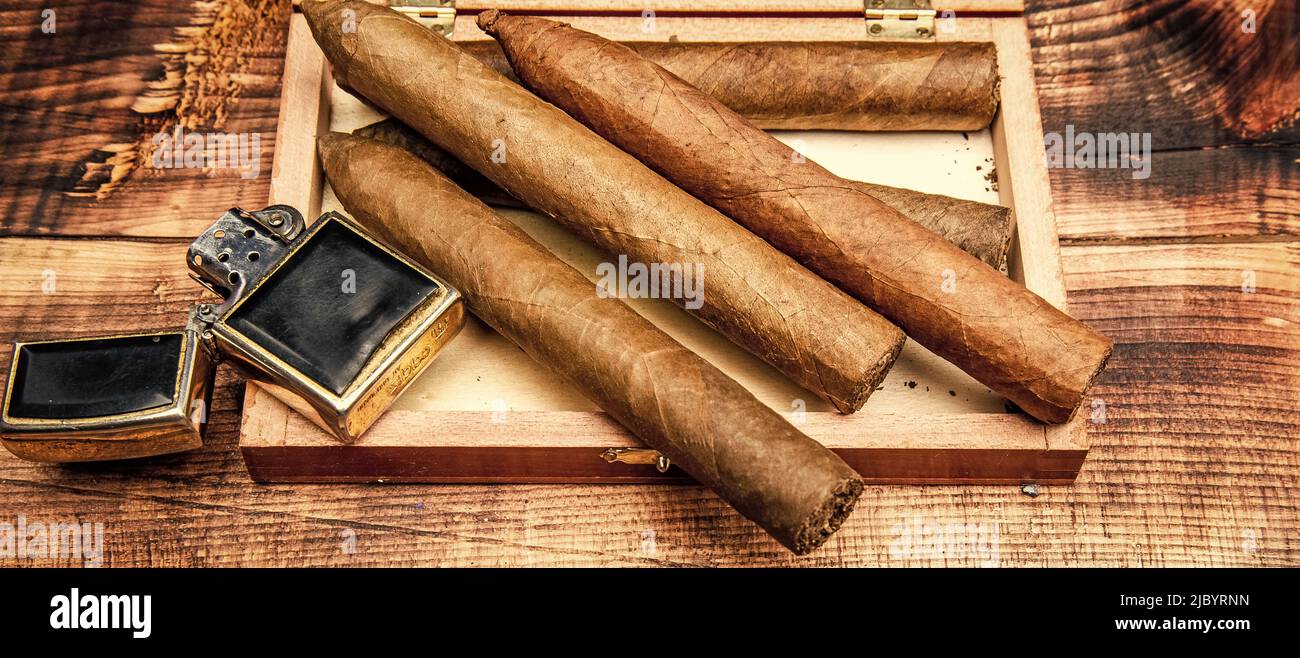 Cigars in box and vintage lighter. Cuban cigars wooden background ...