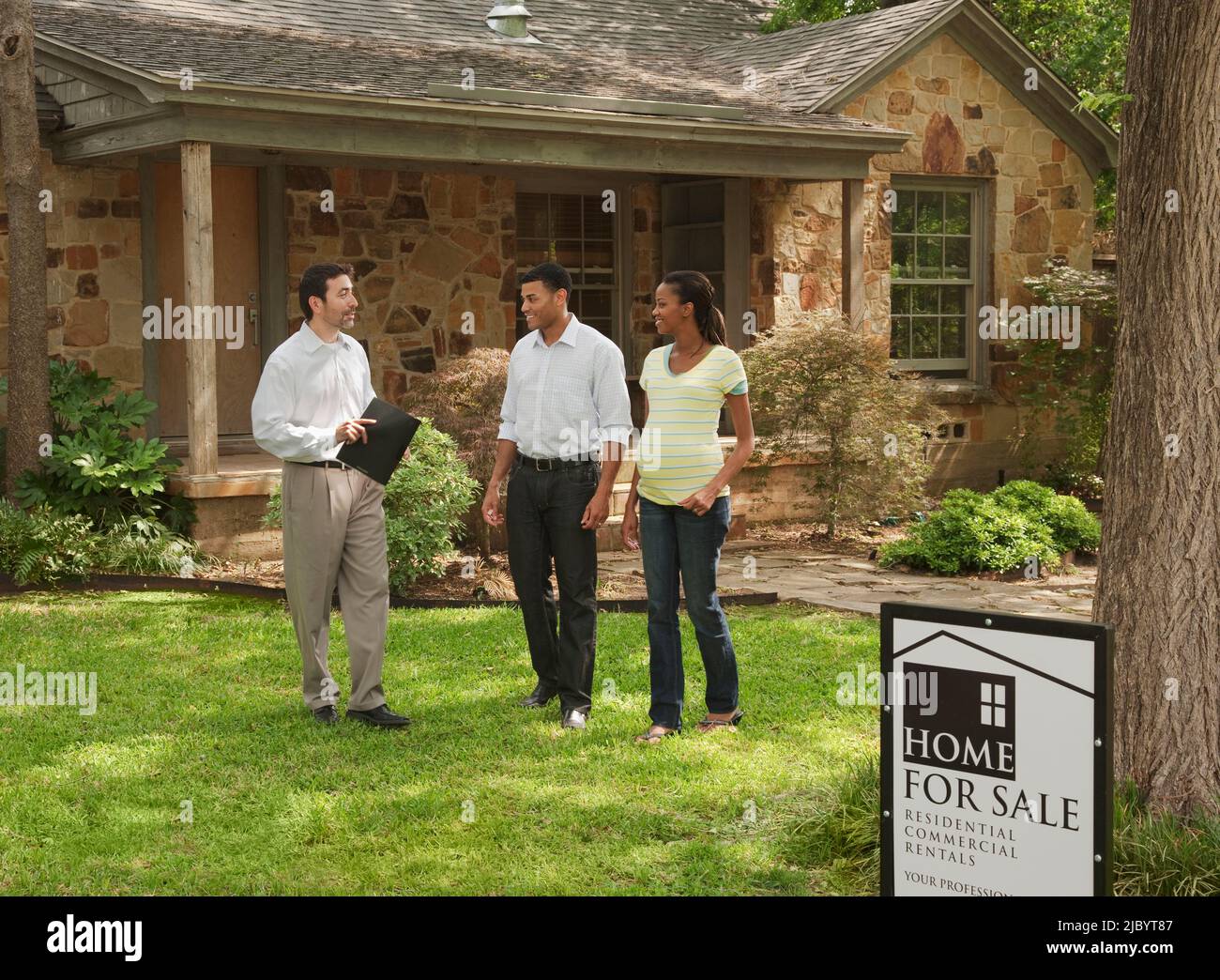 Couple and realtor looking at home for sale Stock Photo - Alamy