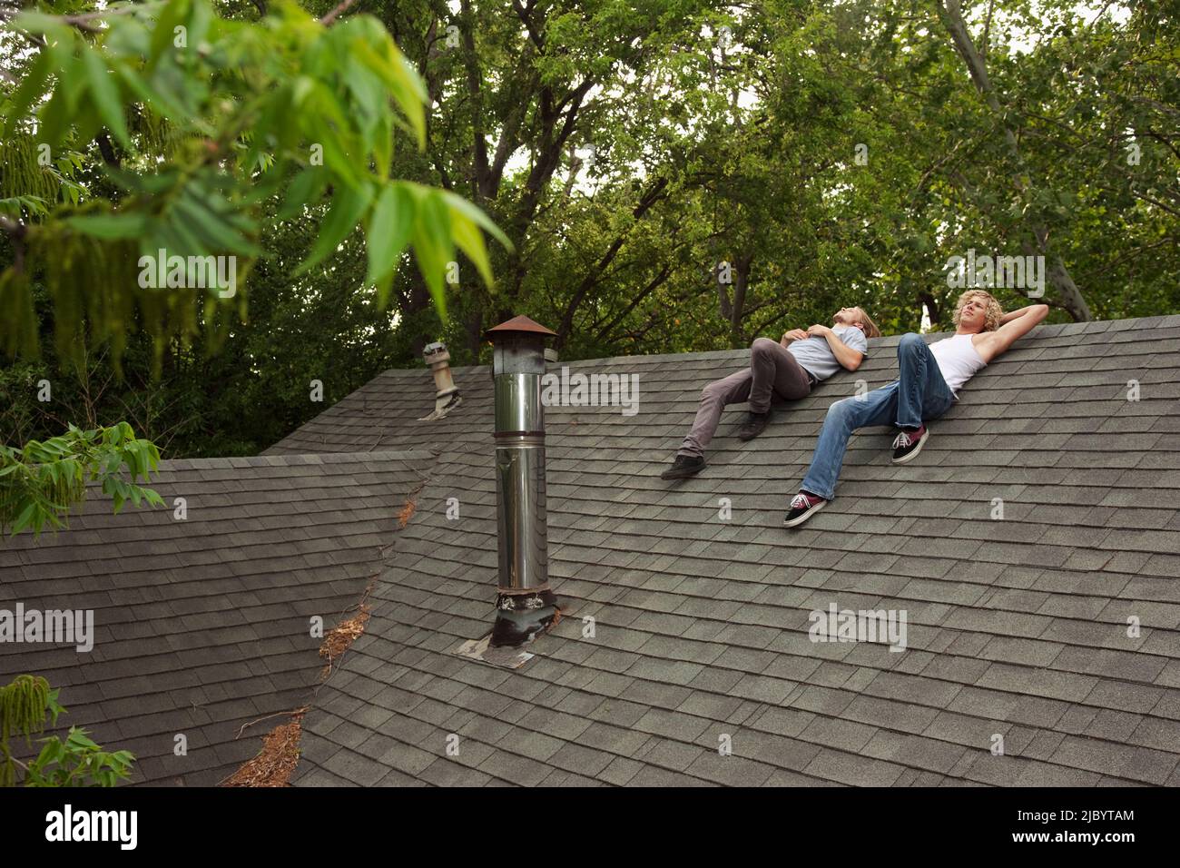 Friends hanging out on roof together Stock Photo - Alamy