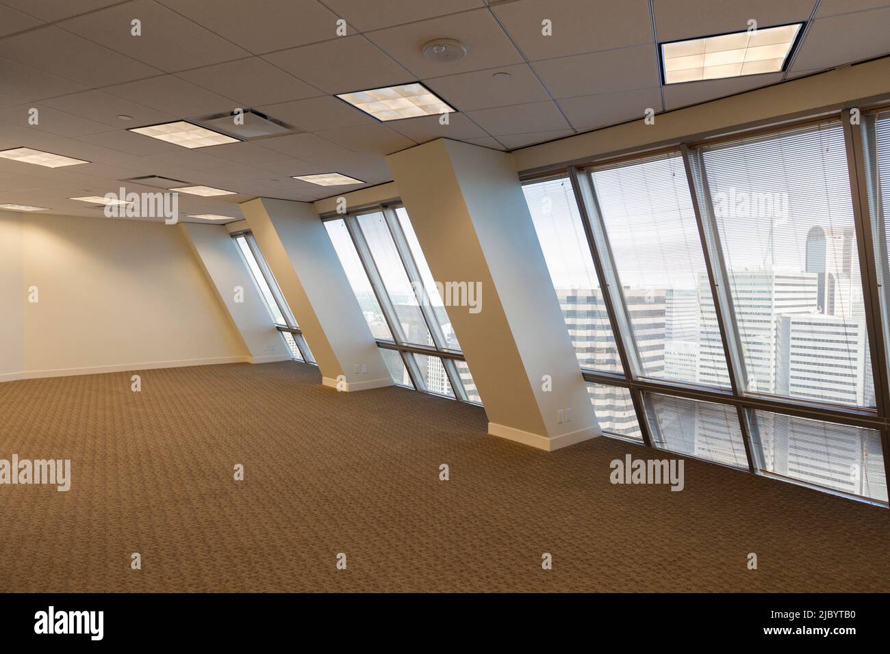 Empty room overlooking cityscape Stock Photo - Alamy