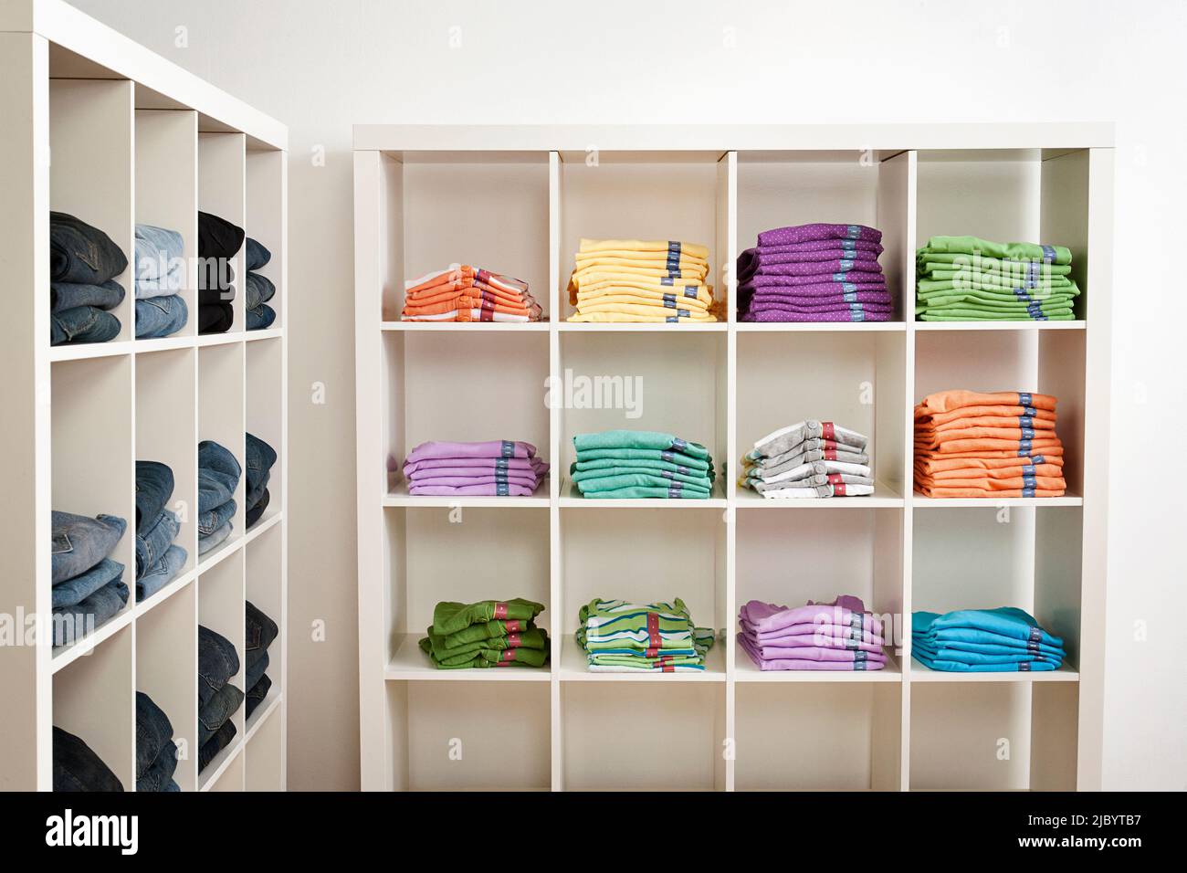 Shelves of clothes in shop Stock Photo - Alamy