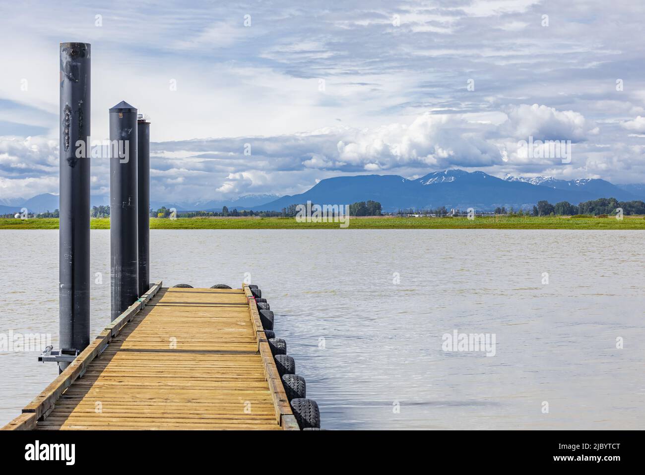 A boat ramp and floating jetty on a river or lake. Wooden pier on a ...