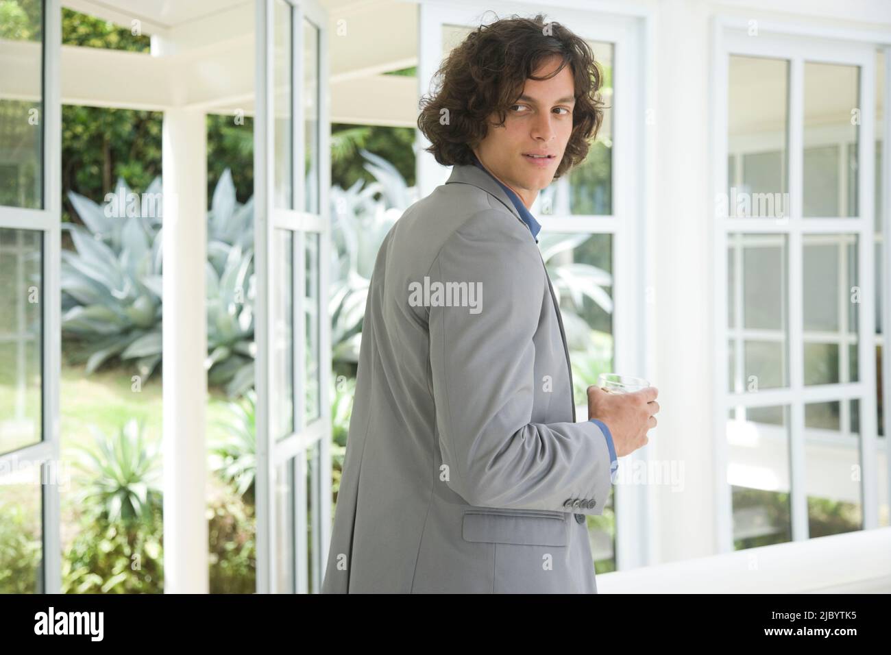 Man glancing over his shoulder Stock Photo - Alamy