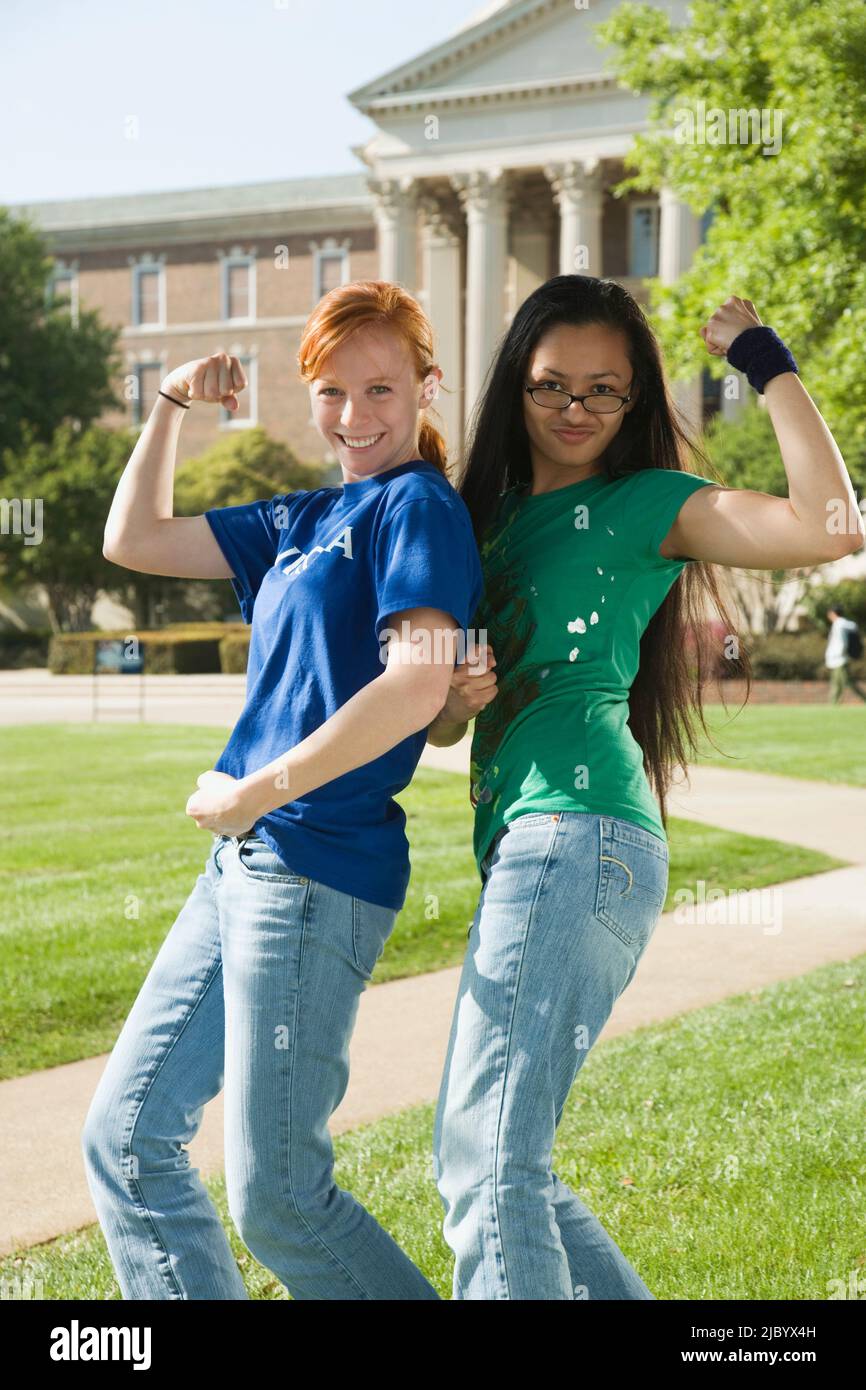 Friends flexing biceps on college campus Stock Photo - Alamy