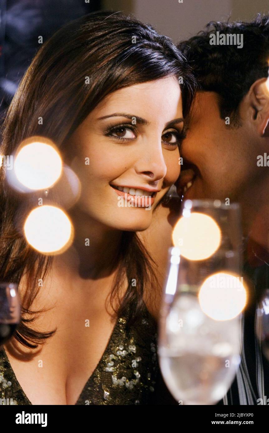 Close up of multi-ethnic couple telling secret Stock Photo - Alamy