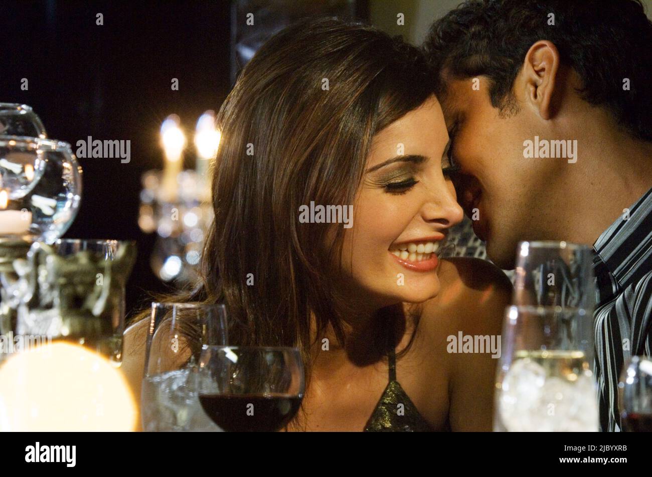 Close up of multi-ethnic couple telling secret Stock Photo - Alamy