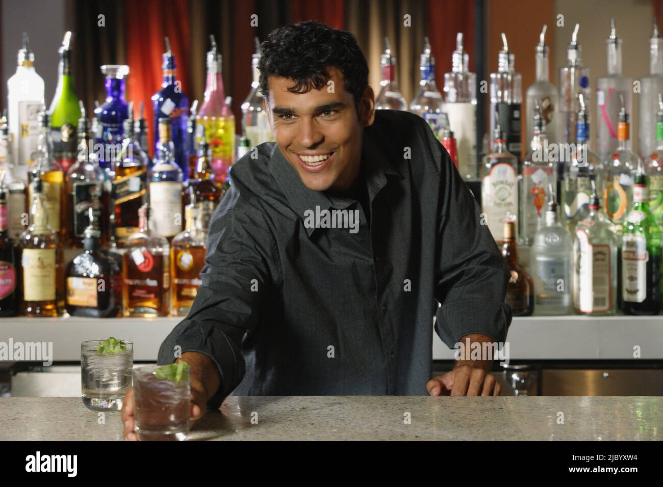 Hispanic male bartender making drink hi-res stock photography and ...