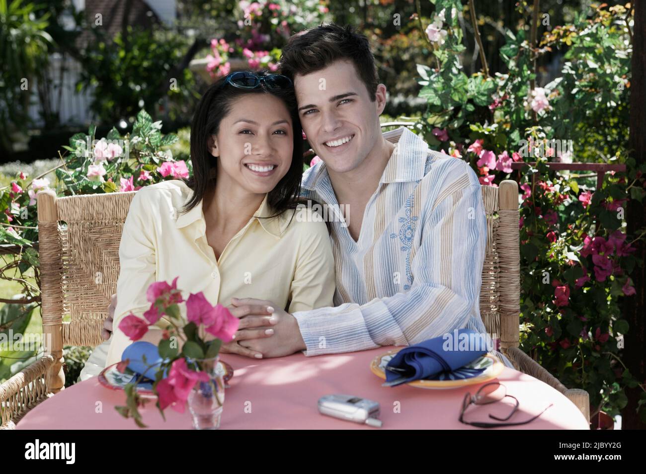 Couple hugging at outdoor table Stock Photo - Alamy