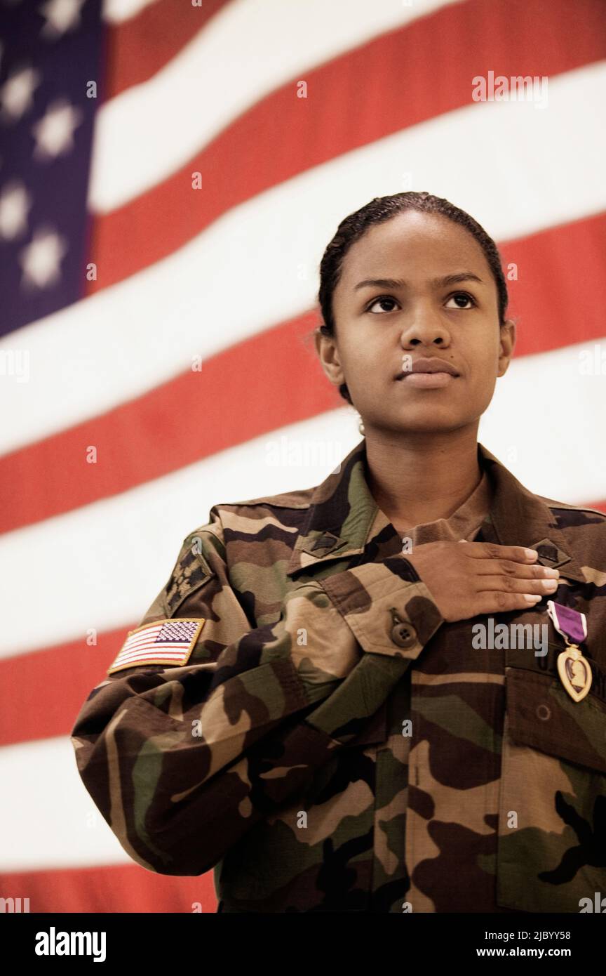 Hispanic female soldier in front of American flag Stock Photo - Alamy
