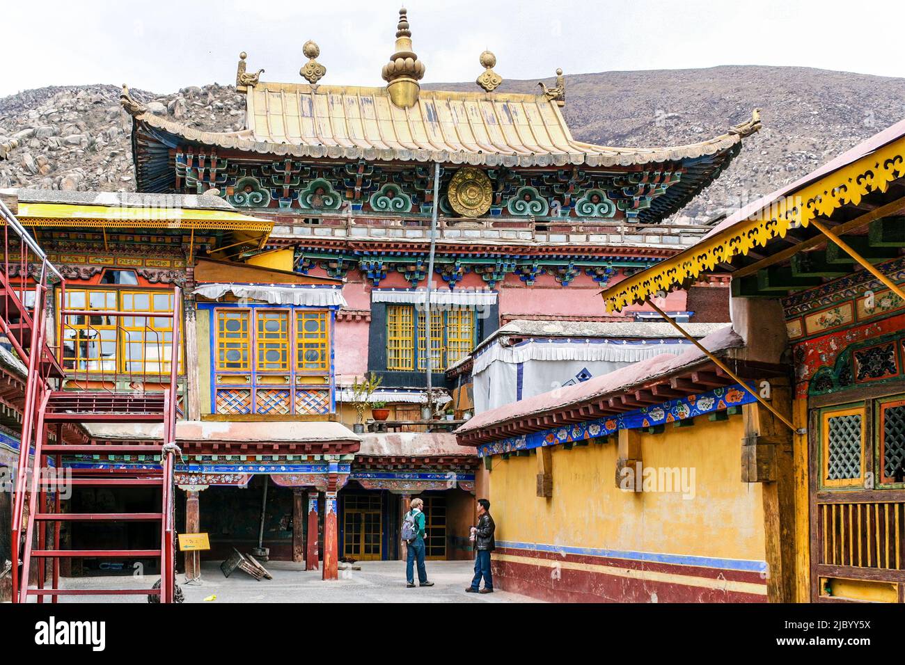 A tourist and his Tibetan guide discussed the history of Drepung ...